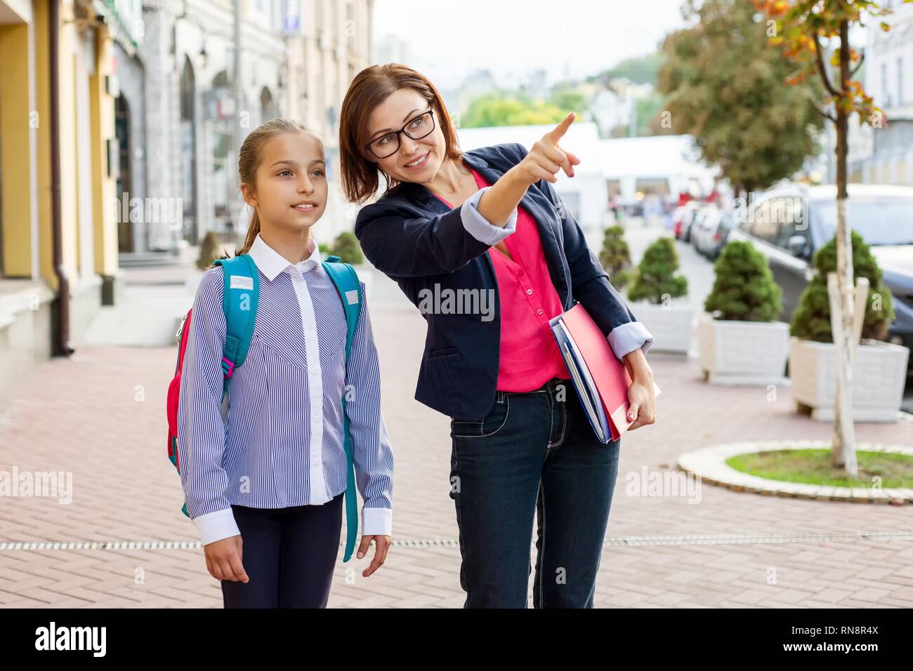 Outdoor portrait of schoolgirl and teacher. Urban background Stock ...