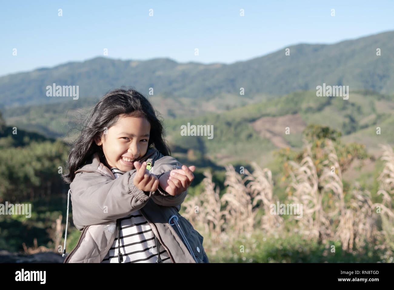 A little girl showing symbol of miniheart wich love symbolic of Korea ...