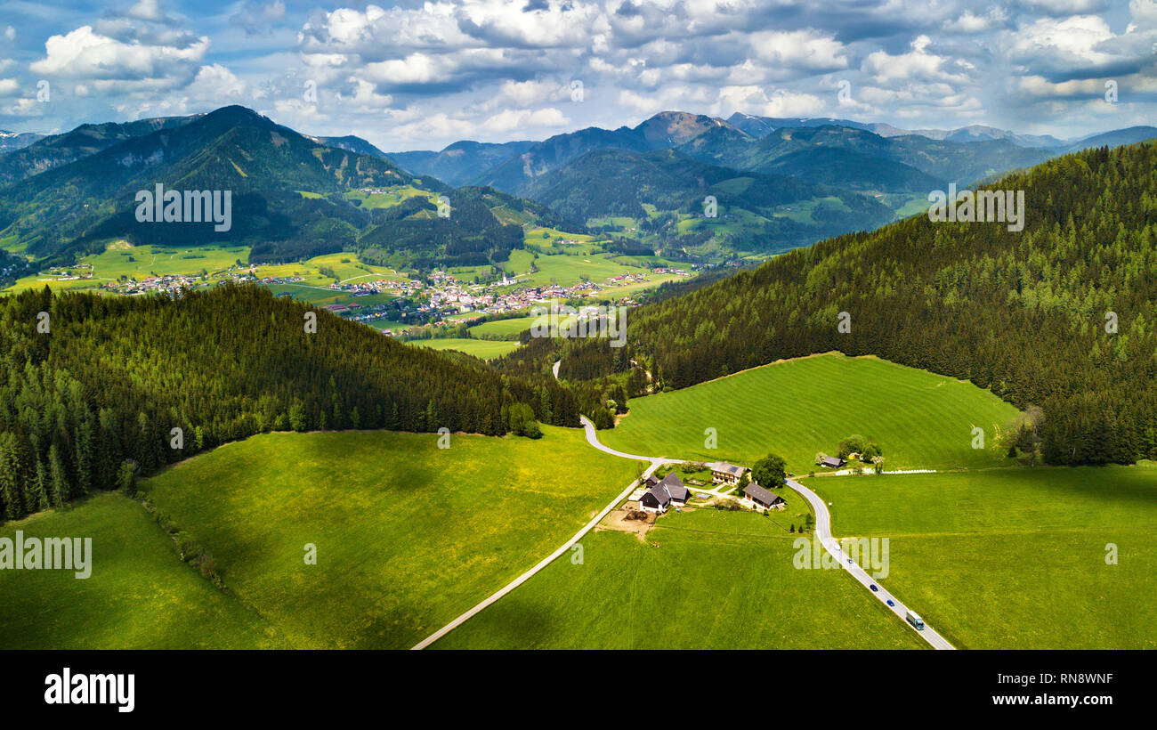 Spring travel in Austria. Green fields and meadows in Alps mountains ...