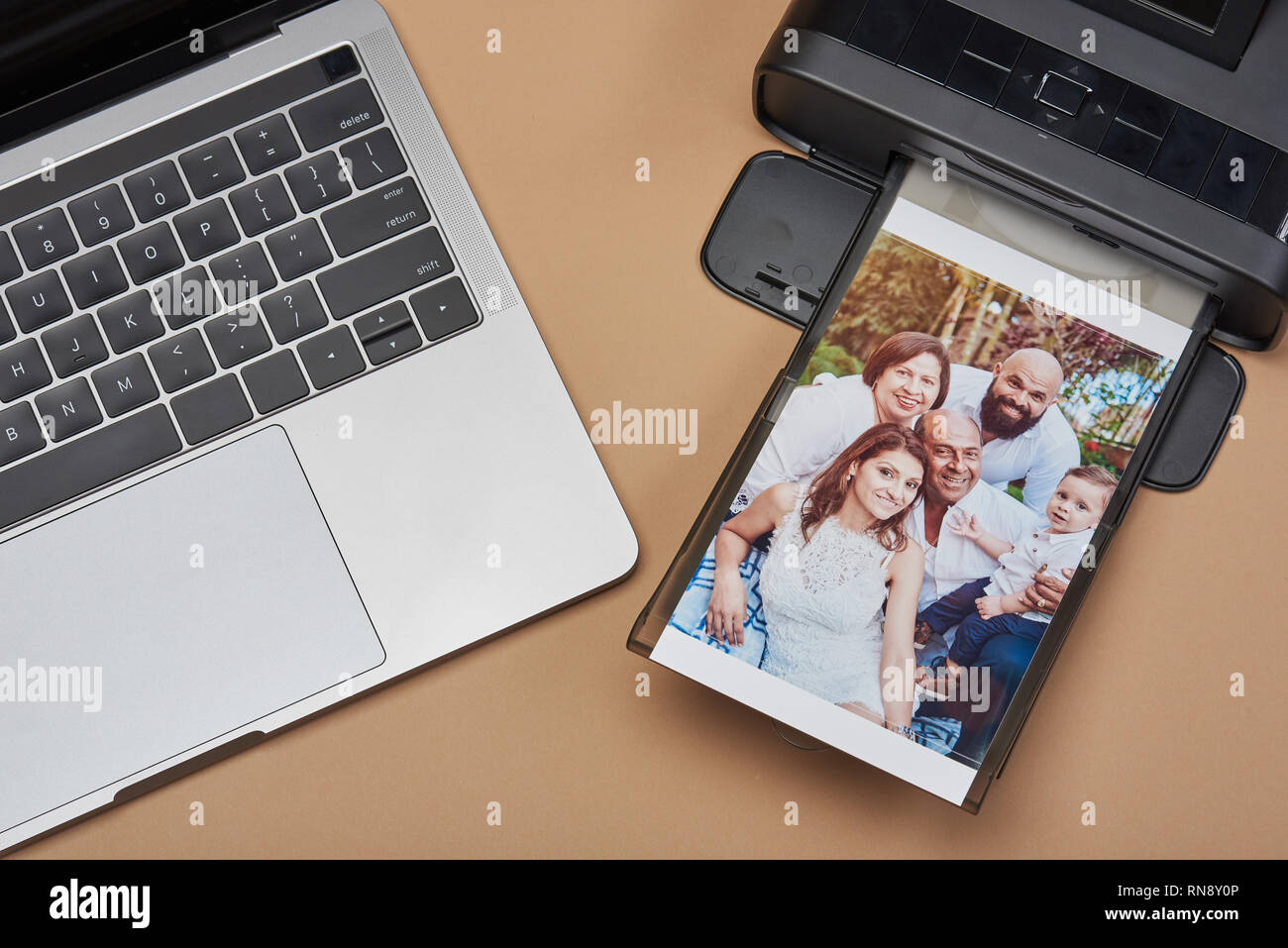 Compact printer with family image and laptop above top view Stock Photo ...