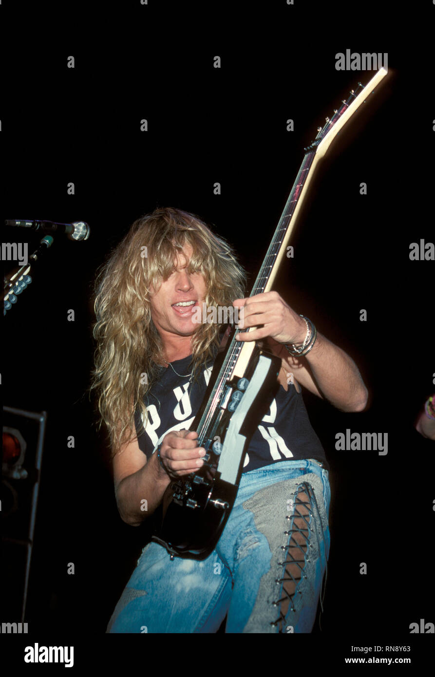 Danger Danger guitarist is shown performing on stage during a "live ...