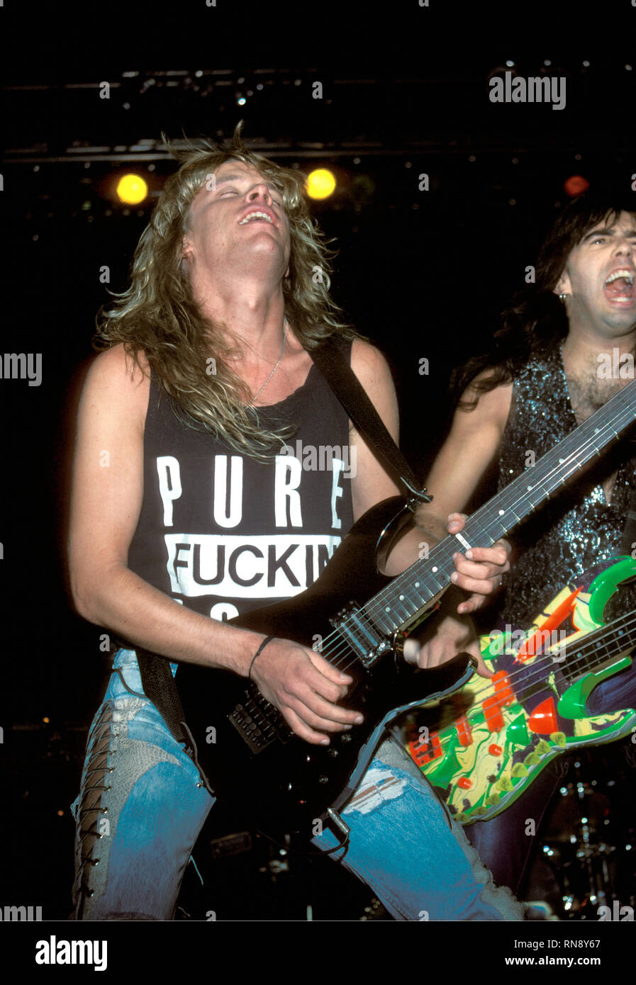 Danger Danger guitarist is shown performing on stage during a "live ...