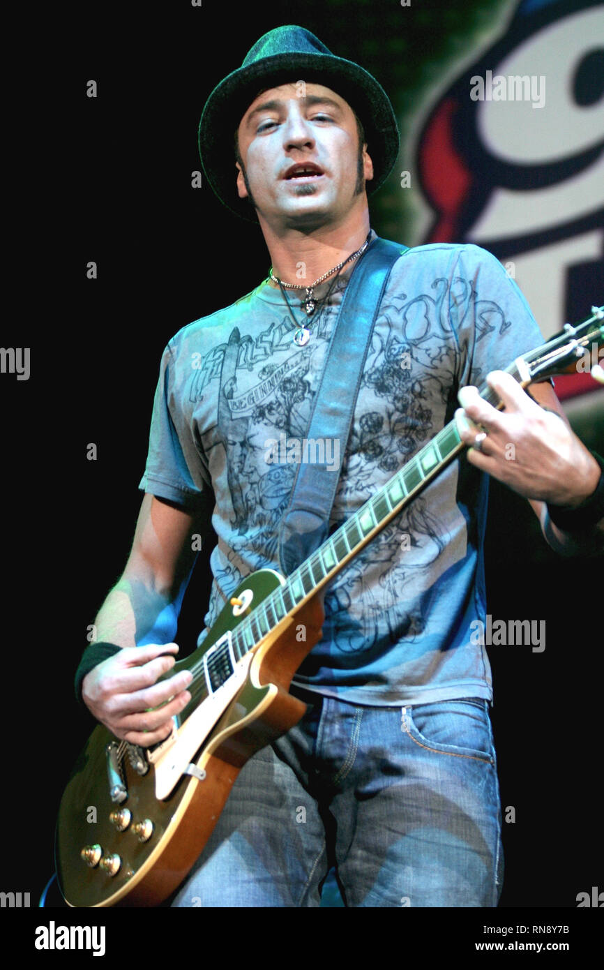 Guitarist in the Daughtry band is shown on stage during a concert ...
