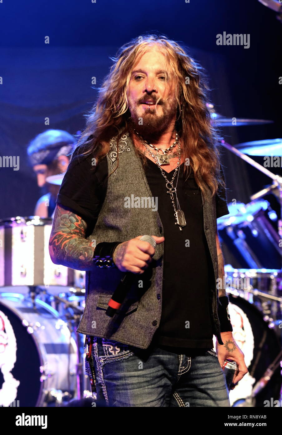 Singer John Corabi is shown performing on stage during a "live" concert ...
