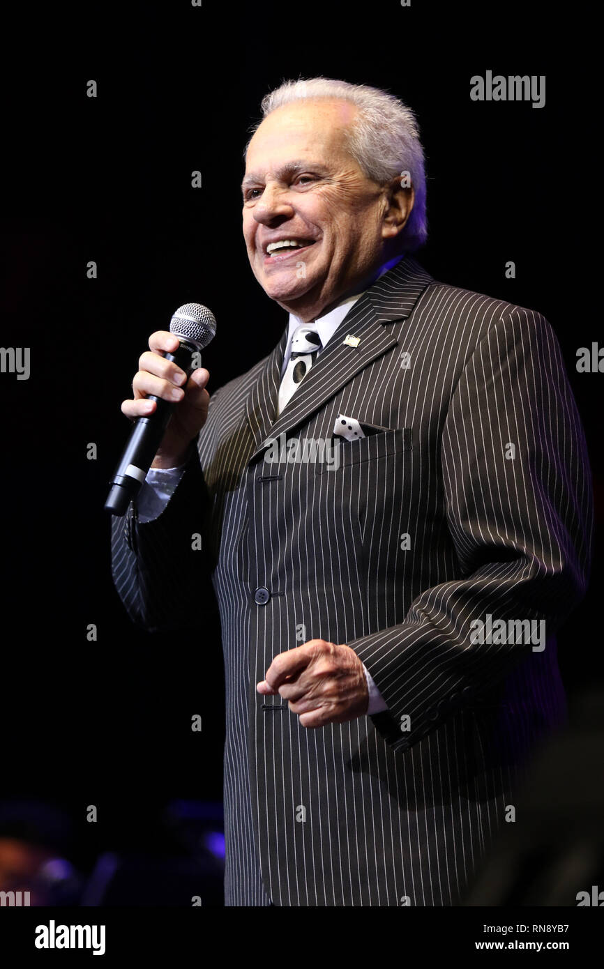 Singer Joey Dee is shown performing on stage during a "live" concert ...