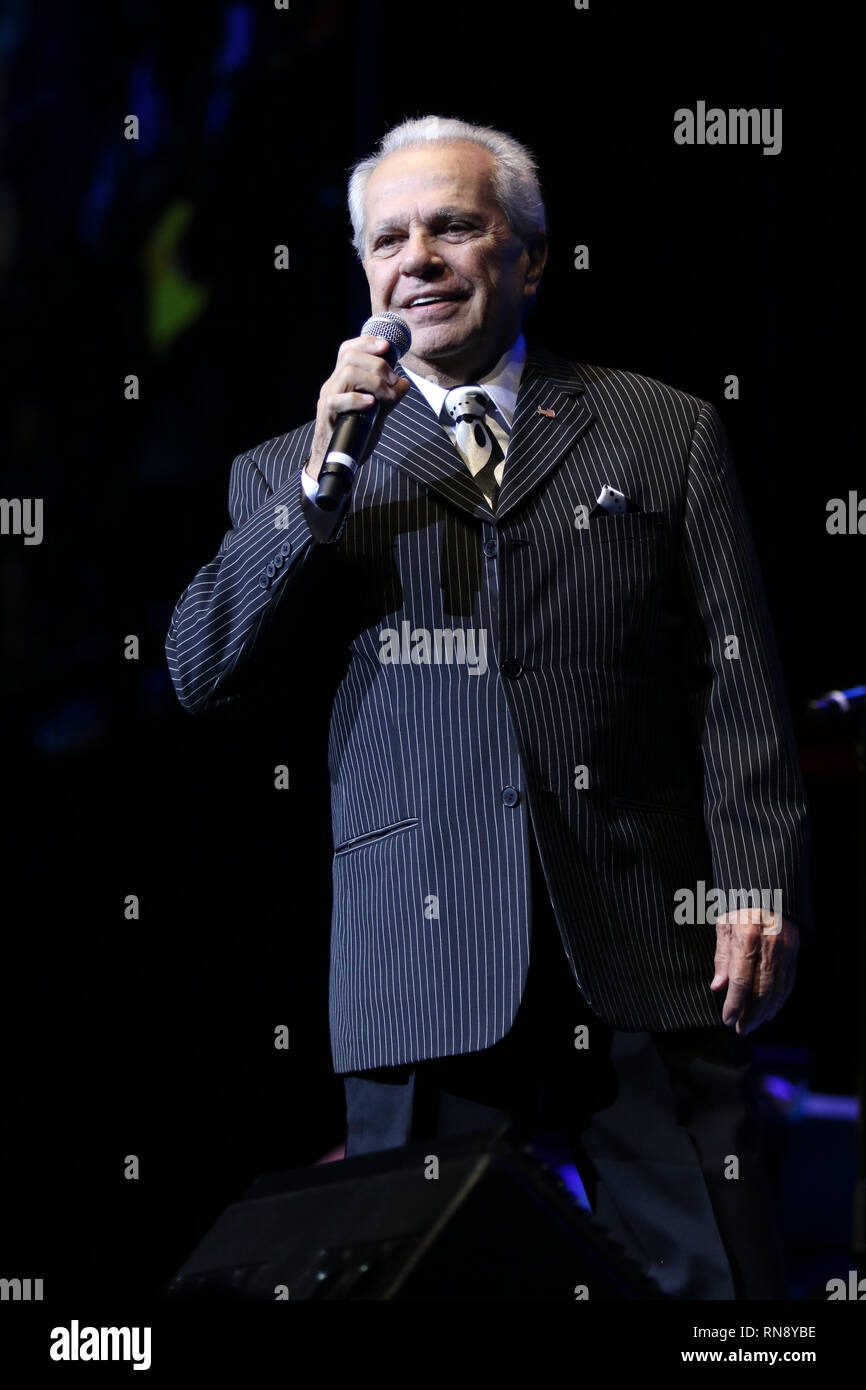 Singer Joey Dee is shown performing on stage during a "live" concert ...