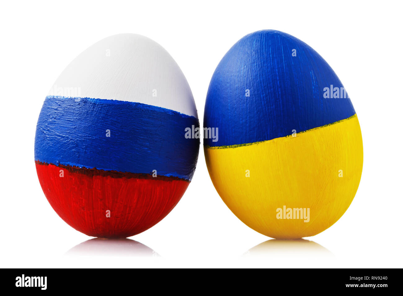 Two Easter eggs painted in the colors of the flags of Russia and ...