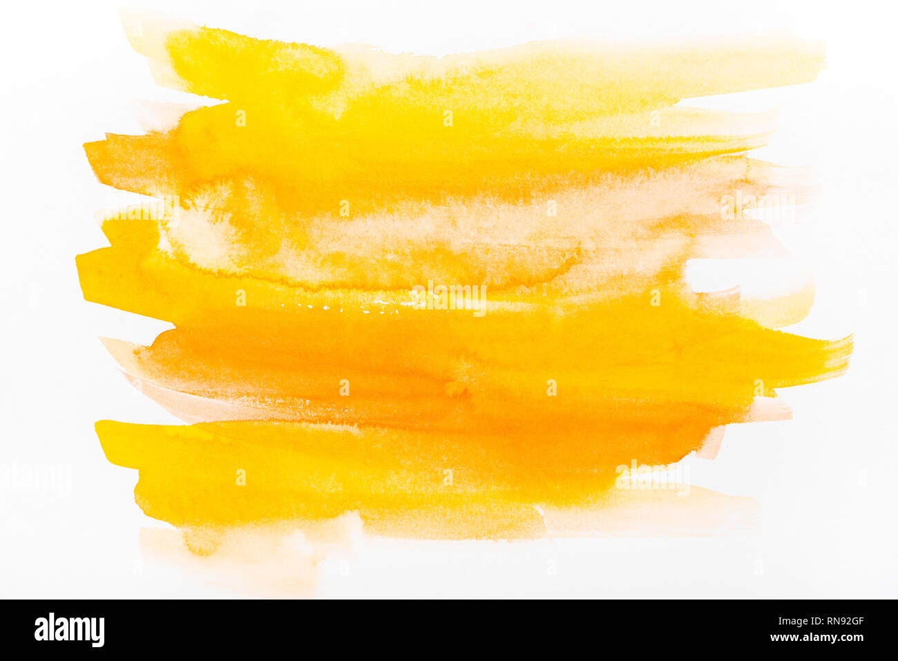 top view of yellow watercolor brushstrokes on white paper Stock Photo ...