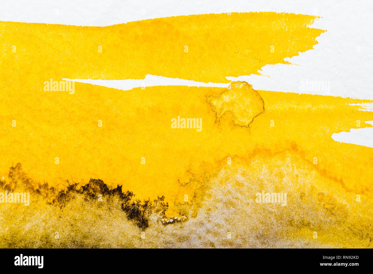 top view of yellow watercolor spill on white paper Stock Photo - Alamy
