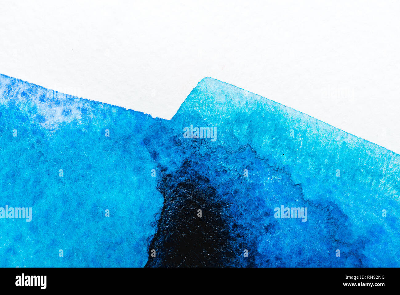 top view of blue watercolor spill on white paper with copy space Stock ...