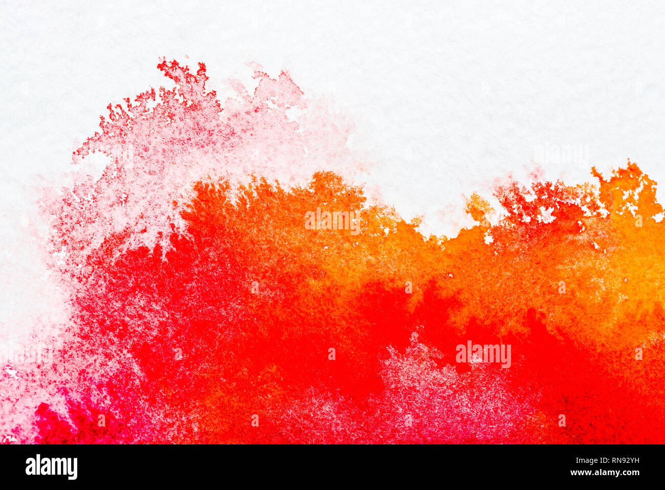 top view of red and orange watercolor spills on white paper Stock Photo ...