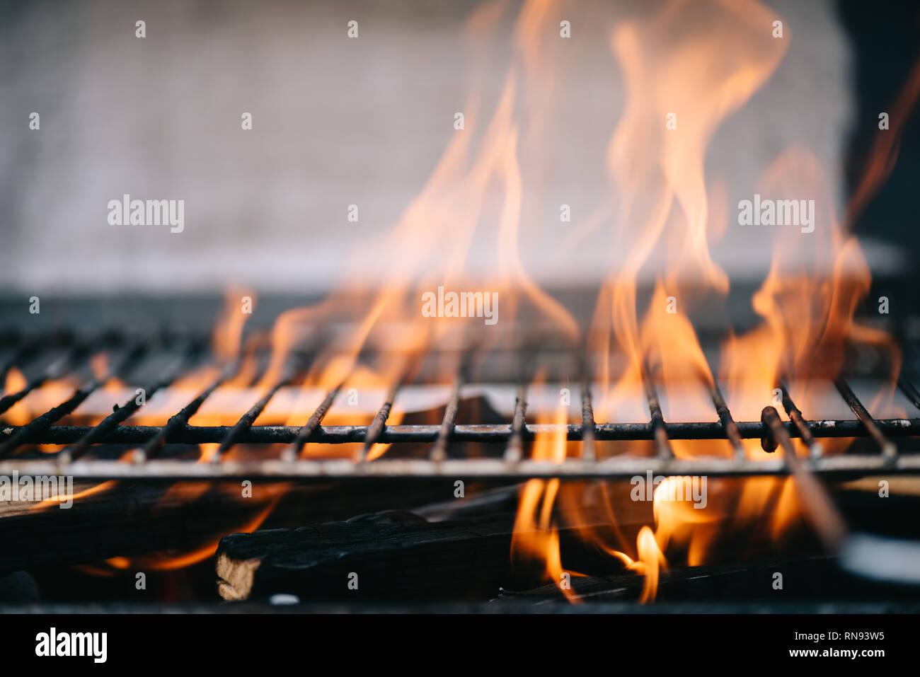 burning firewood with flame through bbq grill grates Stock Photo - Alamy