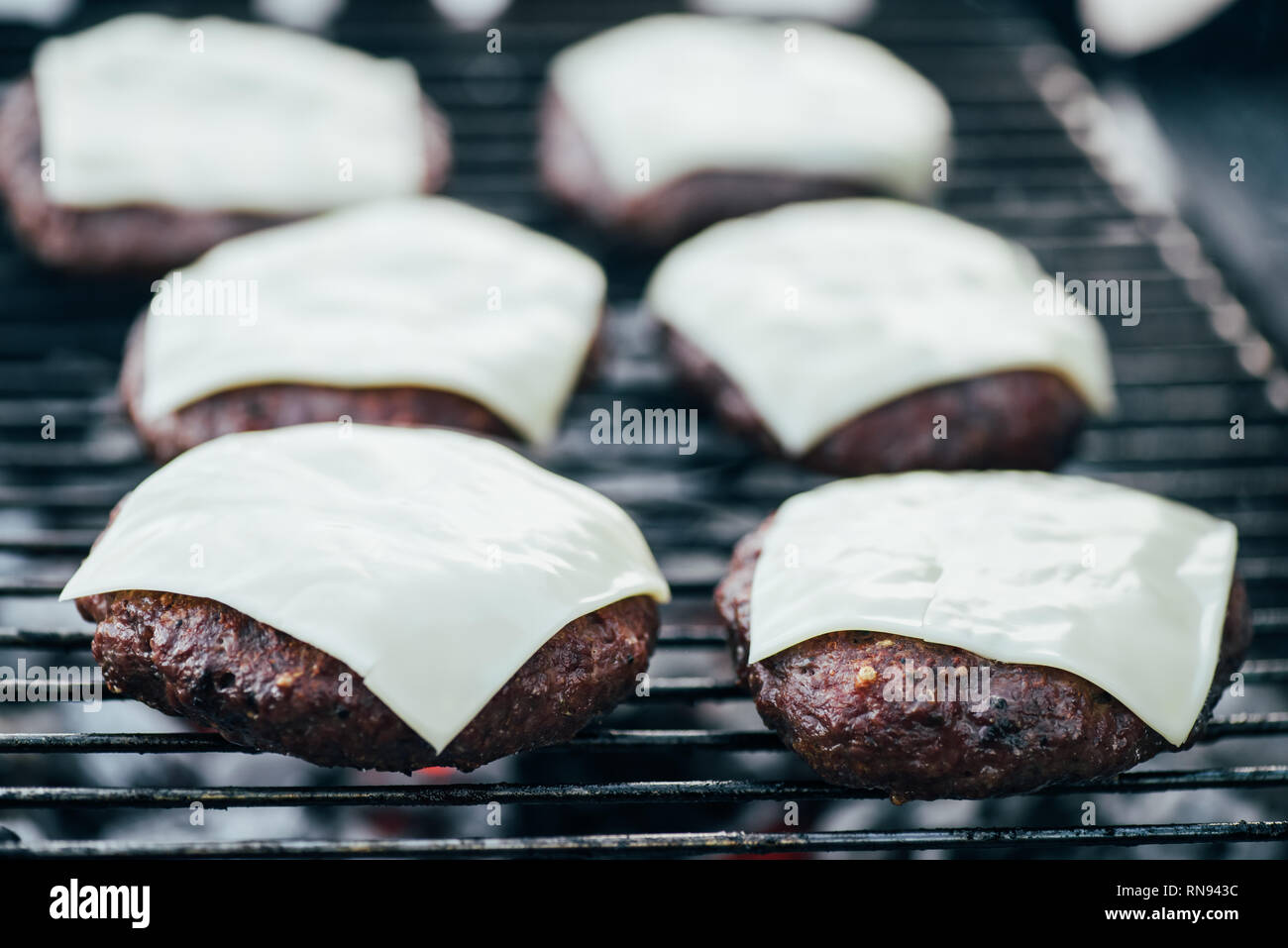 selective focus of fresh delicious burger cutlets with cheese grilling ...
