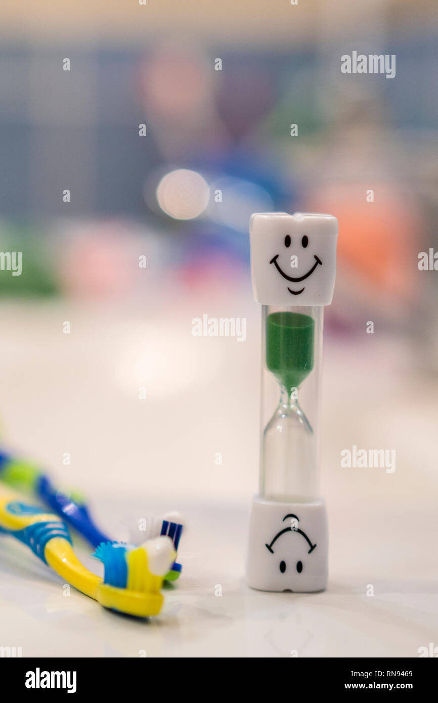 Concept of recommended time to brush your teeth. Soft focus. Two ...