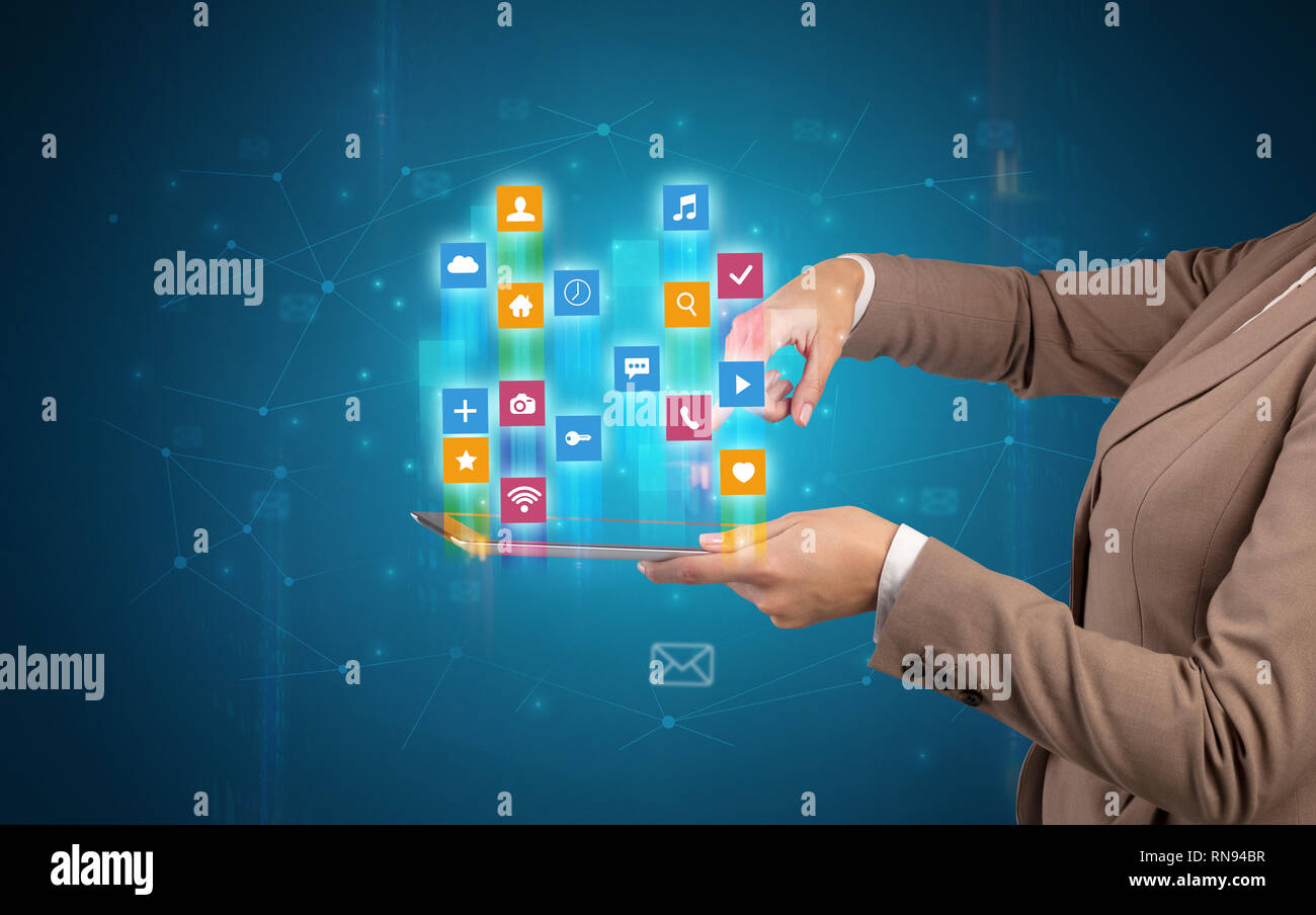 Female elegant hand holding tablet with colourful application icons ...
