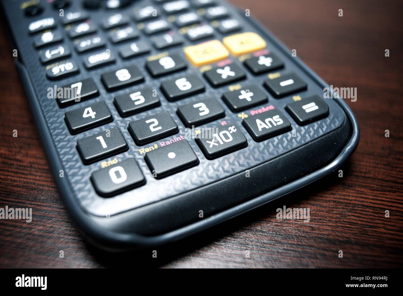 Scientific calculator close up on a wood table Stock Photo - Alamy