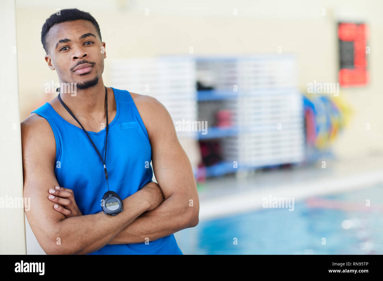 Swimming coach standing pool looking hi-res stock photography and ...