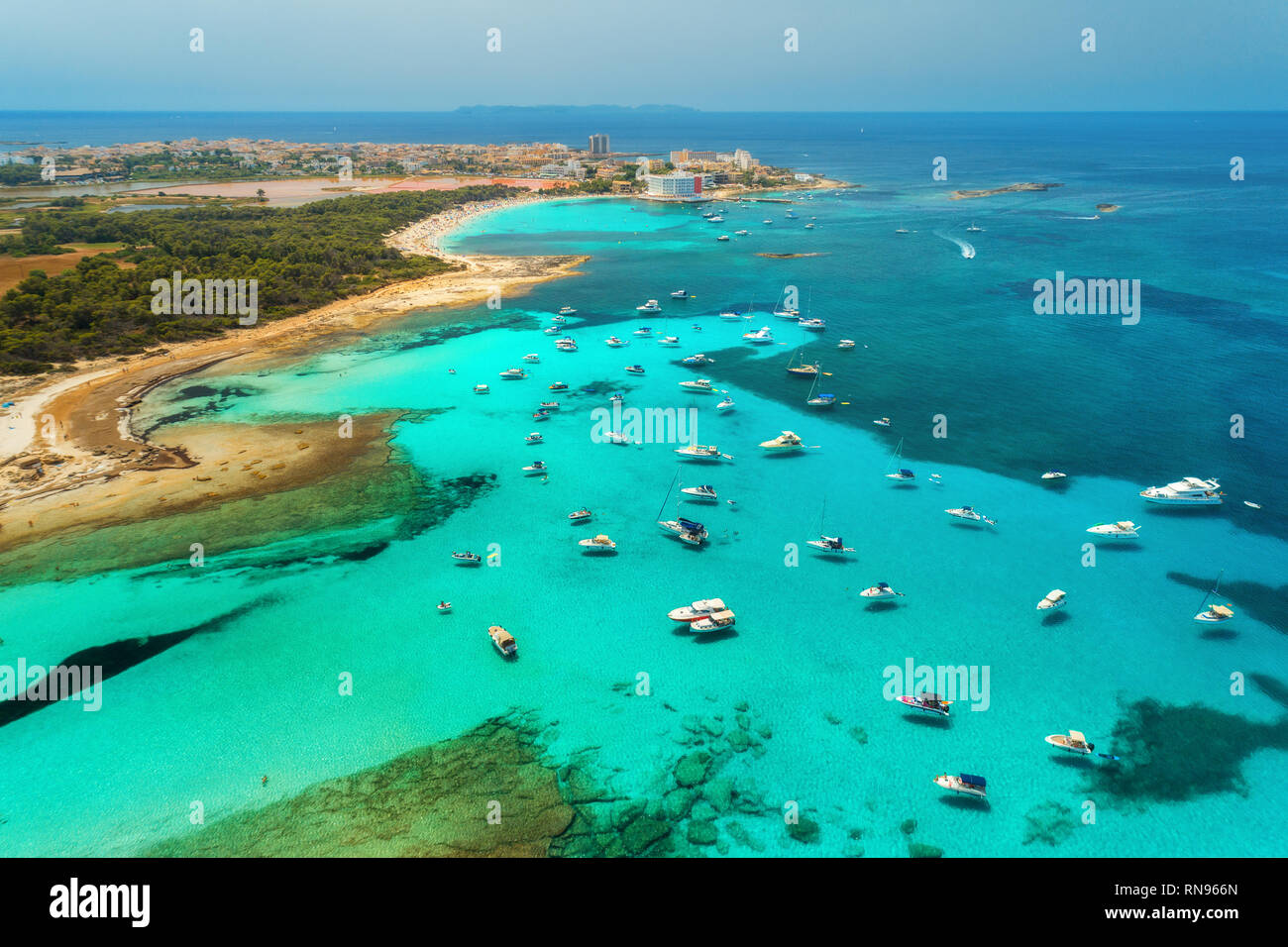 Boats and luxury yachts in transparent sea at sunset in summer in ...