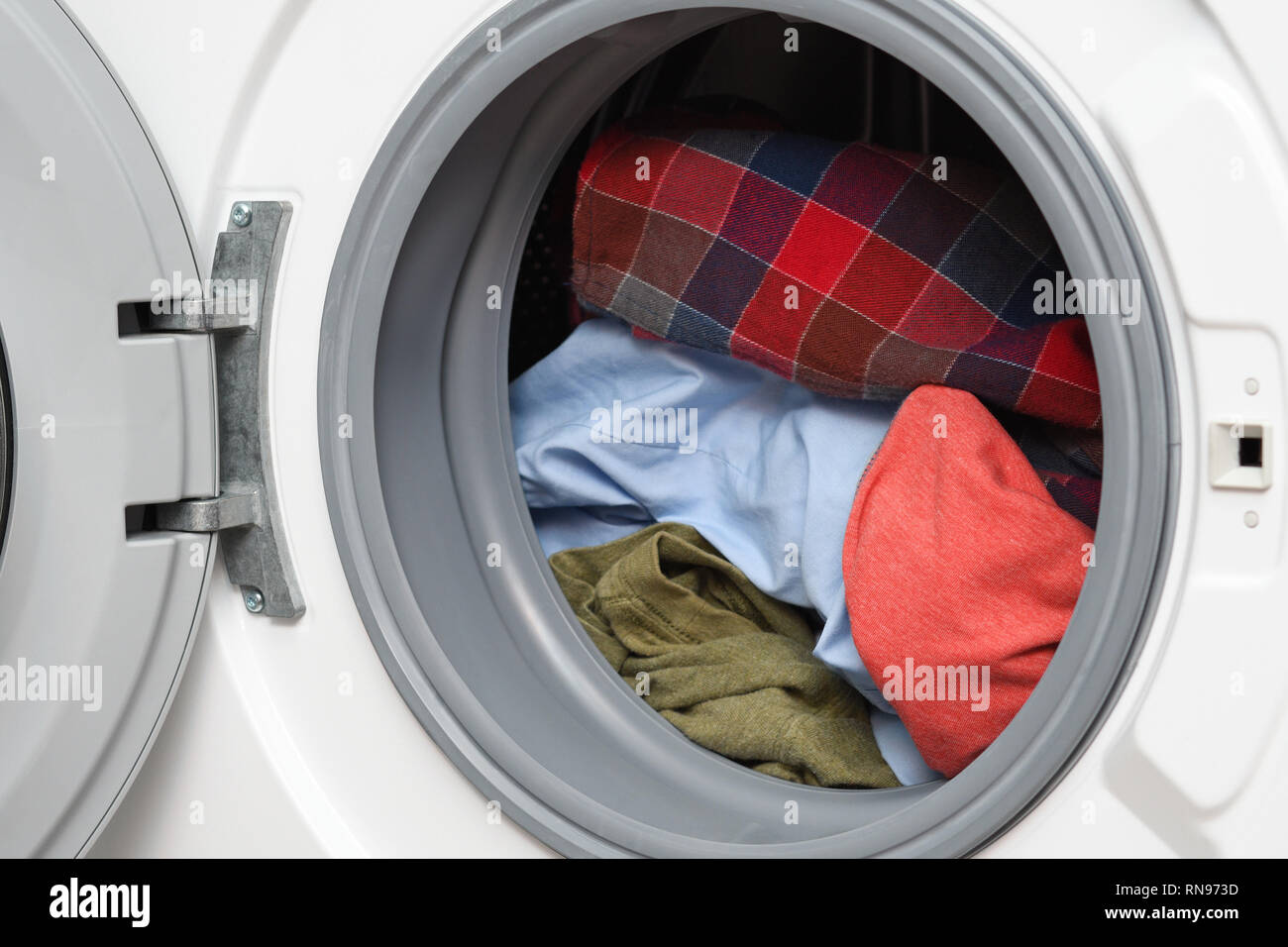 Clothes in open washing machine Stock Photo - Alamy