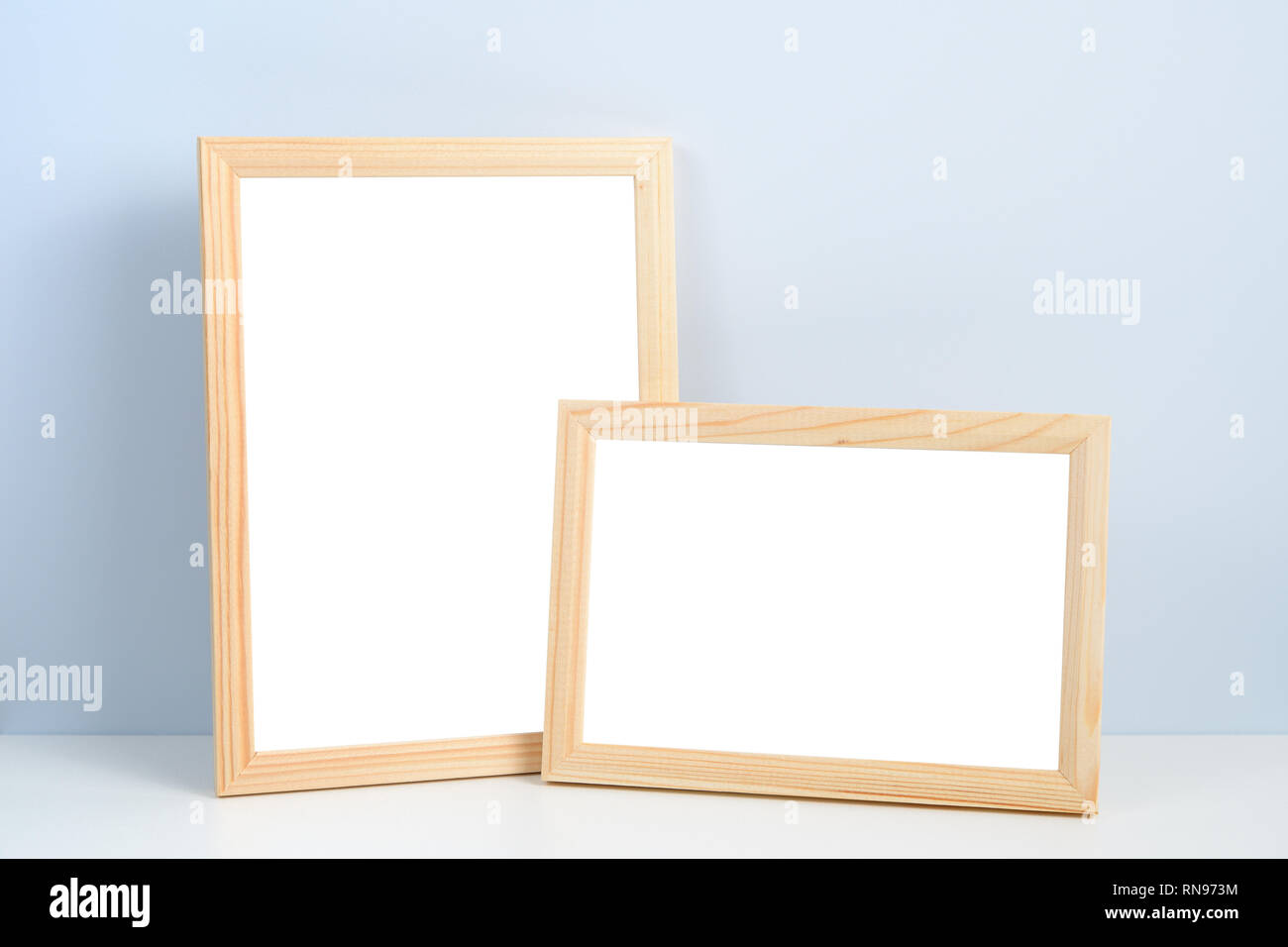 Wooden photo frames standing on shelf Stock Photo - Alamy