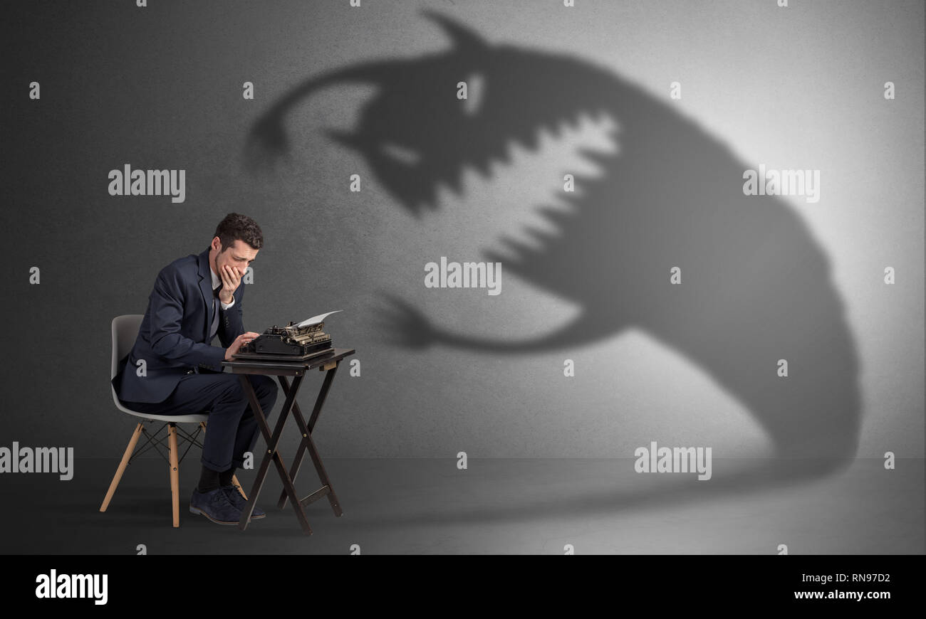 Little hard worker afraid of scary monster shadow Stock Photo - Alamy