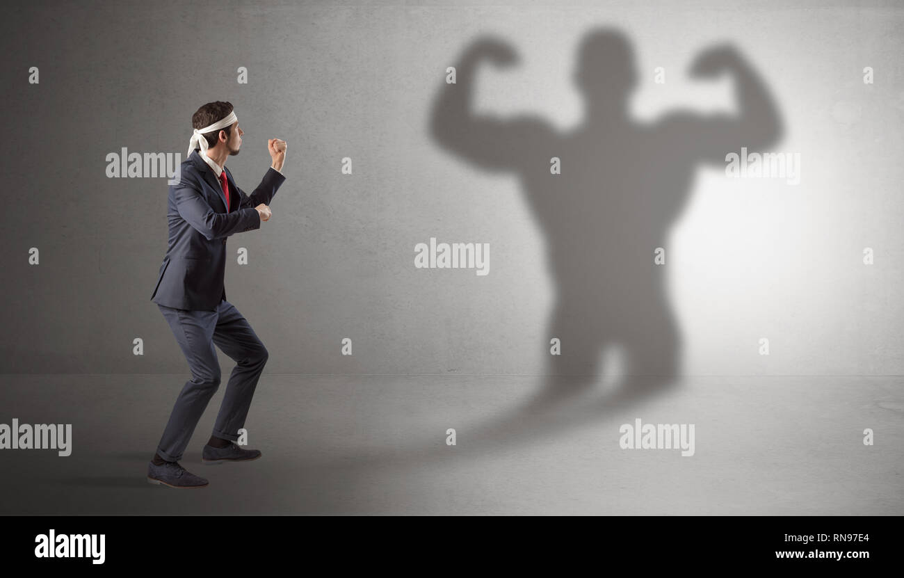 Businessman fighting with his bossy yelling shadow Stock Photo - Alamy