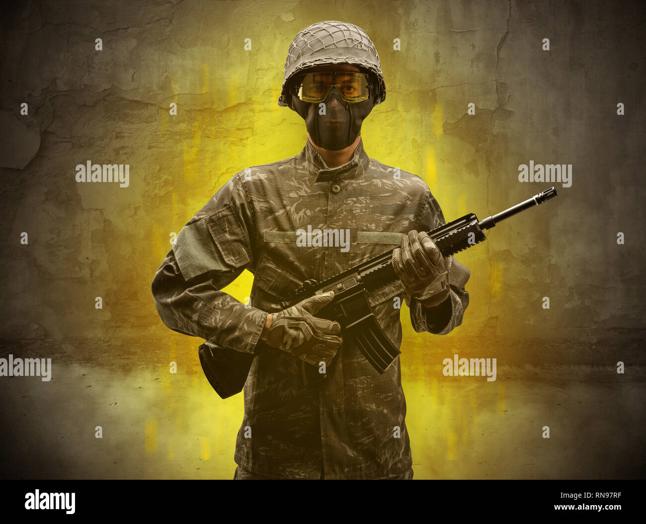 Hazard, menace soldier in a ruined crumbly building with arms on his ...