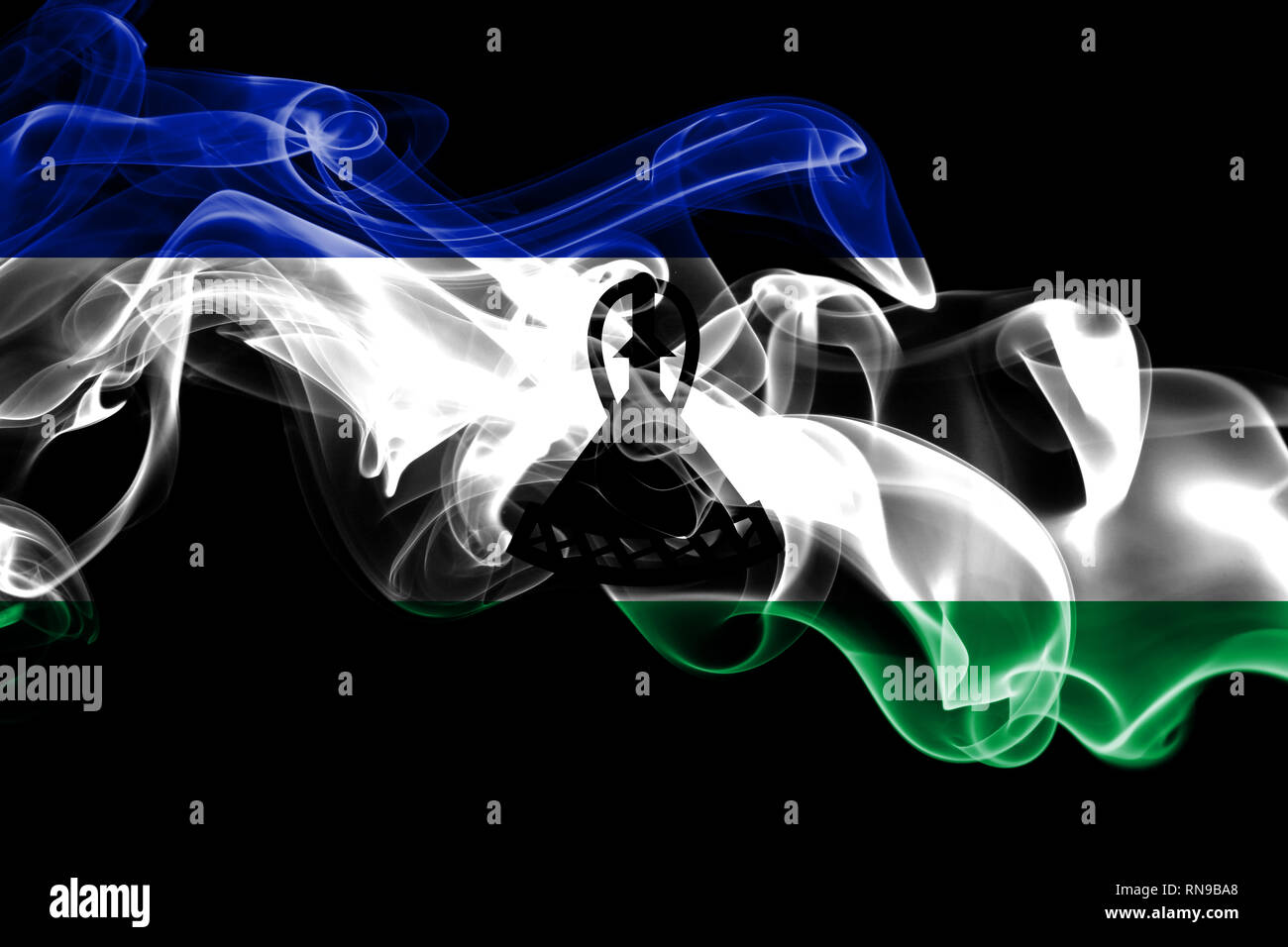 National flag of Lesotho made from colored smoke isolated on black ...