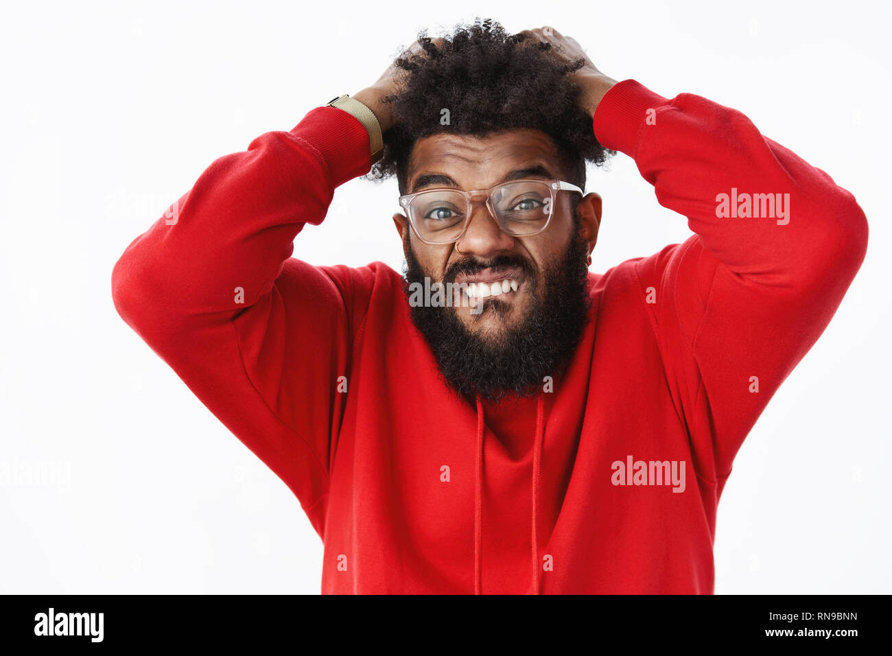 Guy going man ripping hair on head biting lip and frowning, making ...