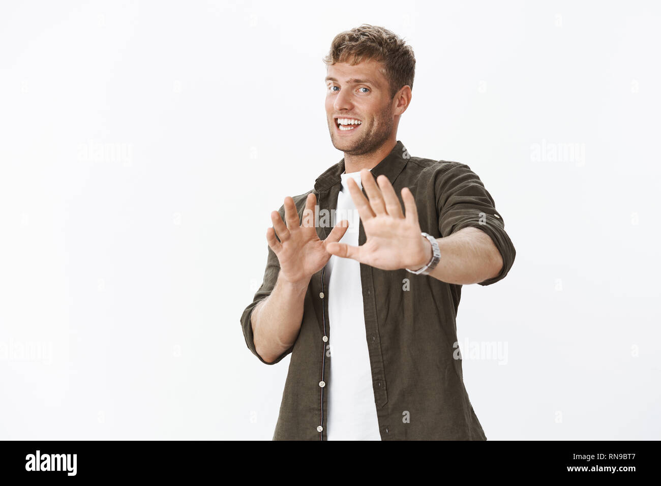 Guy nervously chuckling and tilting backwards with awkward worried ...