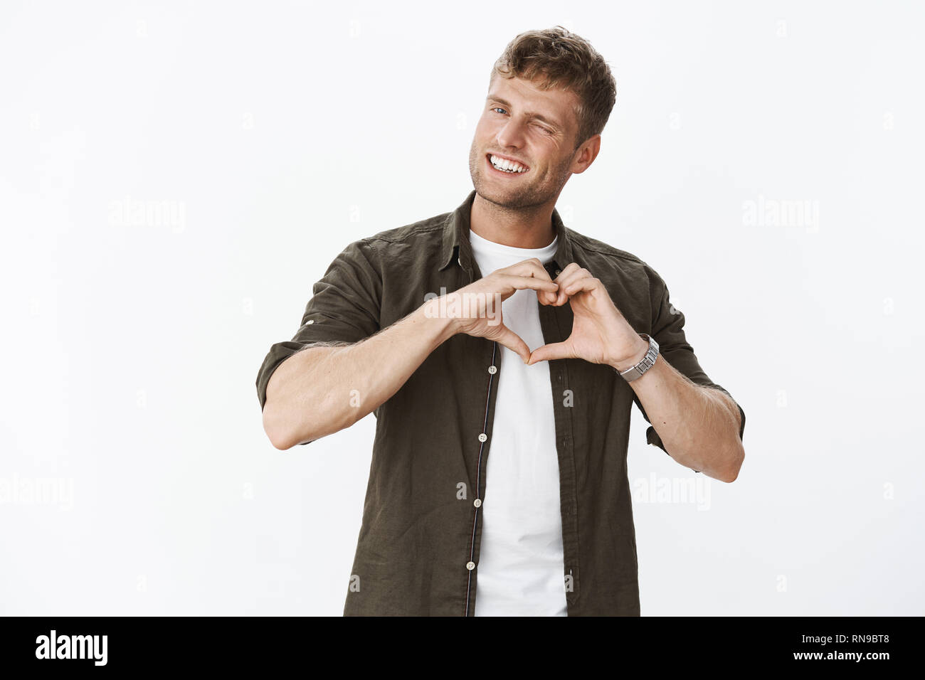 Cool and stylish confident handsome man winking, smiling cheeky and ...