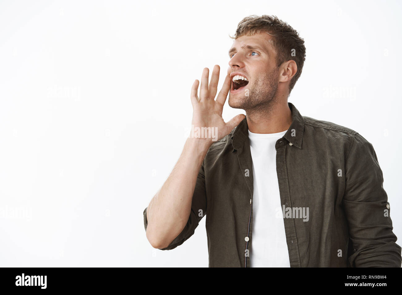 Charming charismatic european blond guy with blue eyes calling someone ...