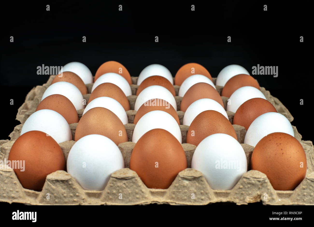 packing of yellow and white chicken eggs arranged in a diagonal ...