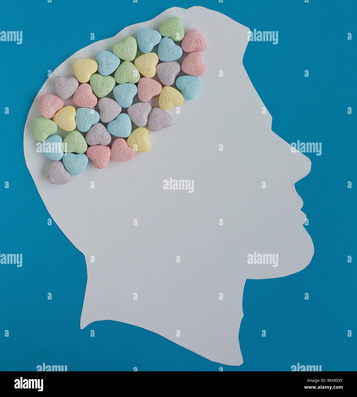Silhouette of a man's head with candy hearts for a brain Stock Photo ...