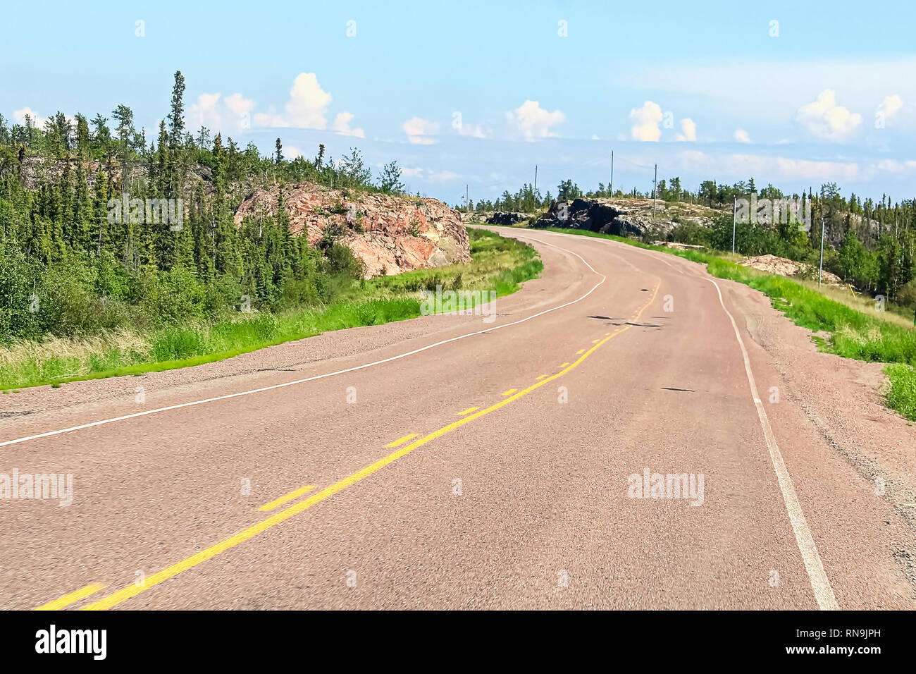 A wavy road commonly caused by permafrost Stock Photo - Alamy