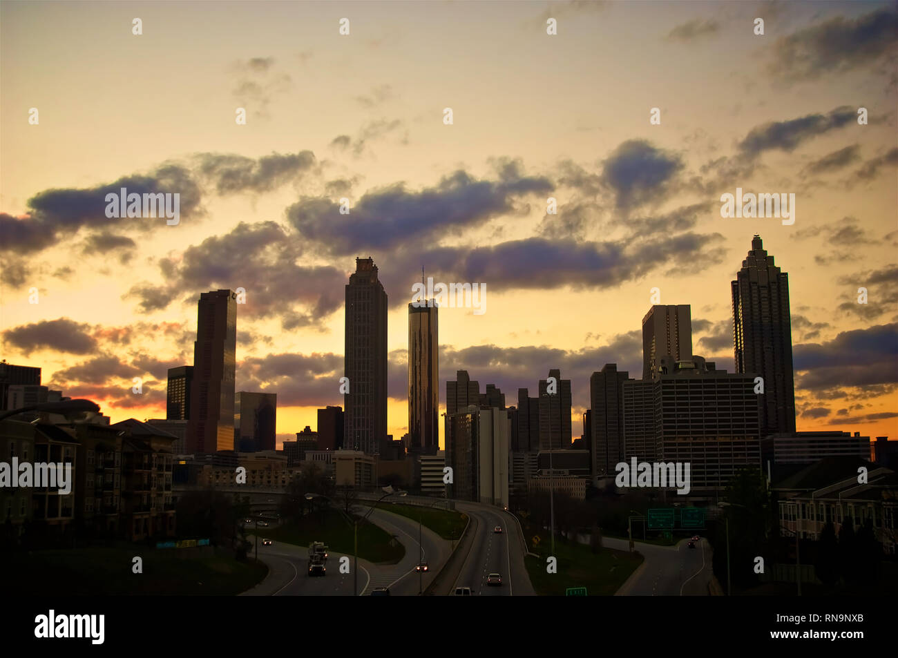 A dramatic silhouette of Georgia's Atlanta skyline bathed in a golden ...