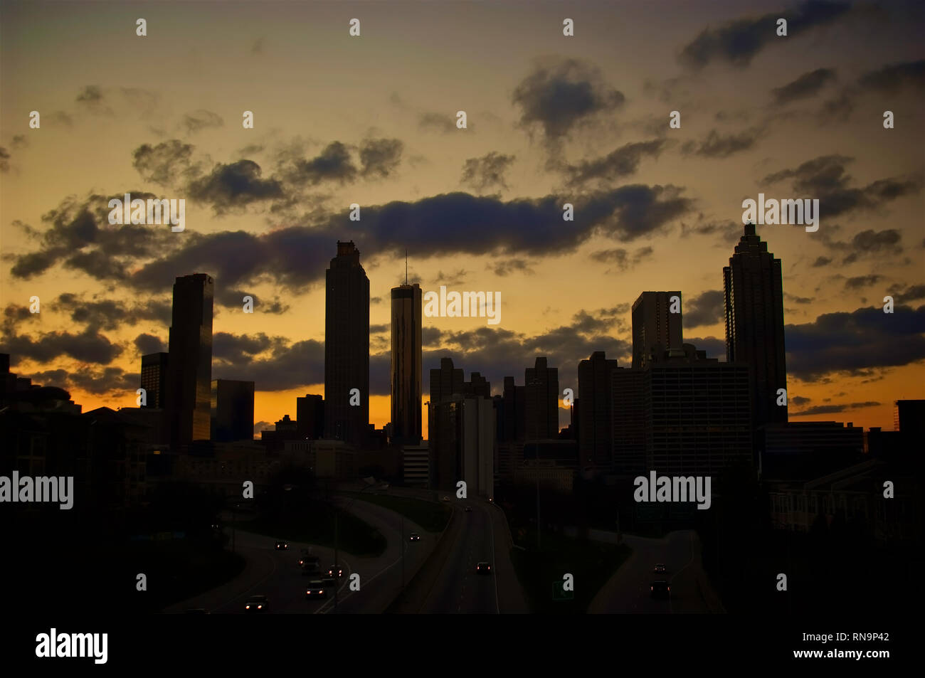 A dramatic silhouette of Georgia's Atlanta skyline bathed in a golden ...