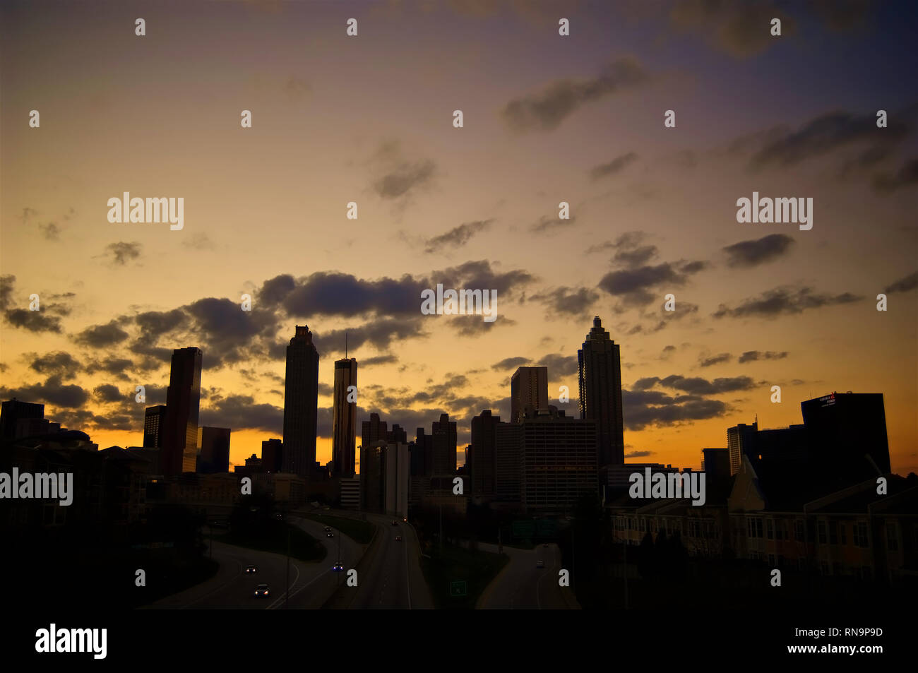 A dramatic sunset over several modern high-rise buildings in Atlanta ...
