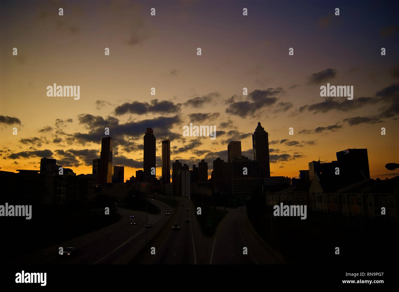 A dramatic sunset over several modern high-rise buildings in Atlanta ...