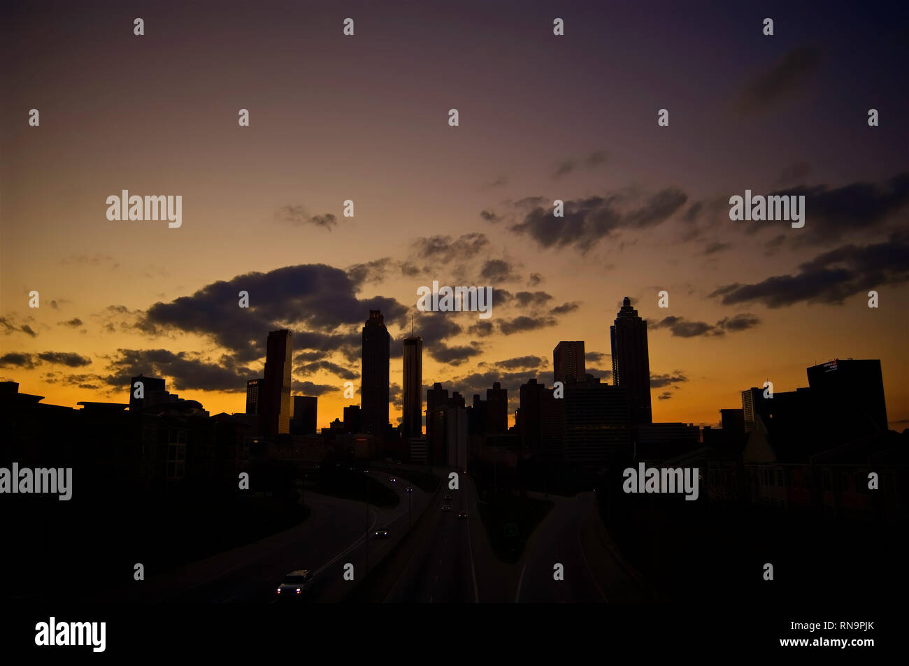 A dramatic sunset over several modern high-rise buildings in Atlanta ...