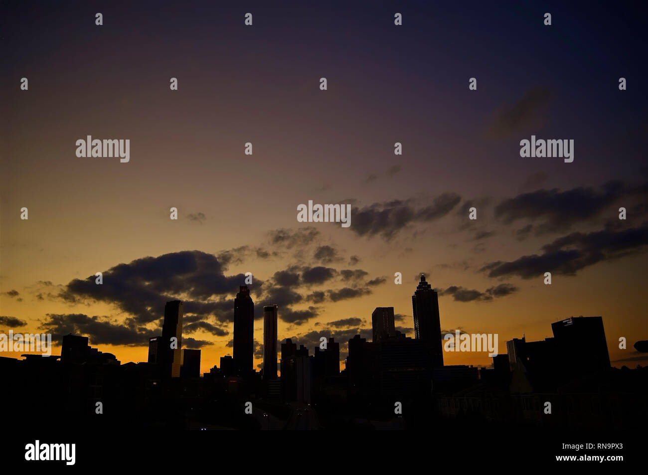 A dramatic sunset over several modern high-rise buildings in Atlanta ...