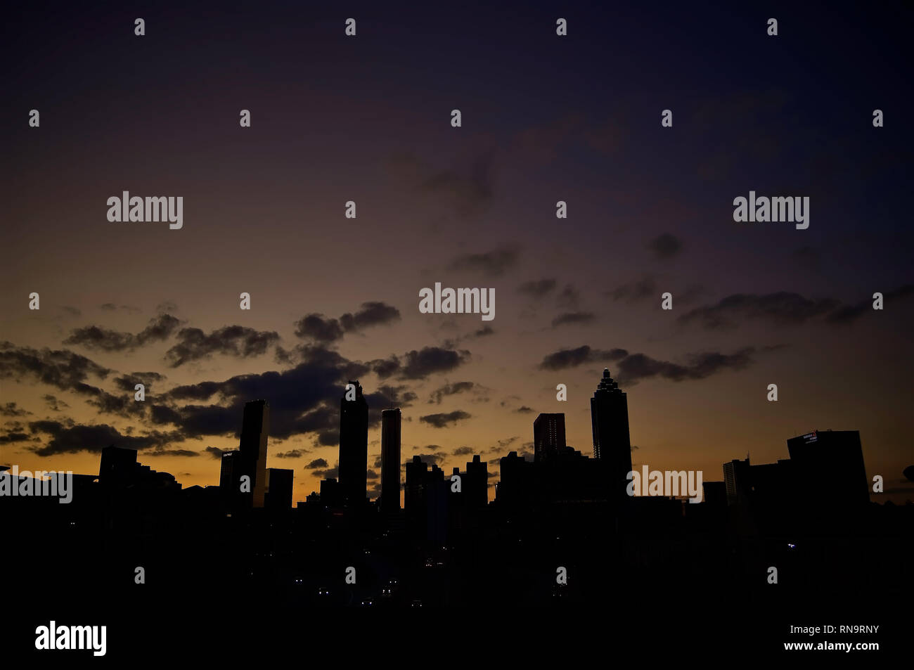 A dramatic sunset over several modern high-rise buildings in Atlanta ...