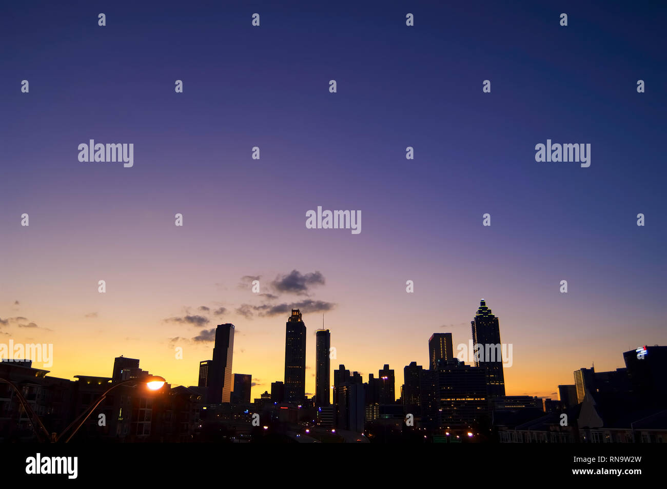 A dramatic sunset over several modern high-rise buildings in Atlanta ...
