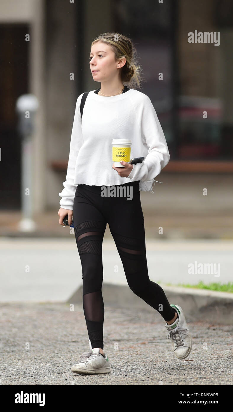Genevieve "G" Hannelius gets a hot drink and chats with friends after a ...