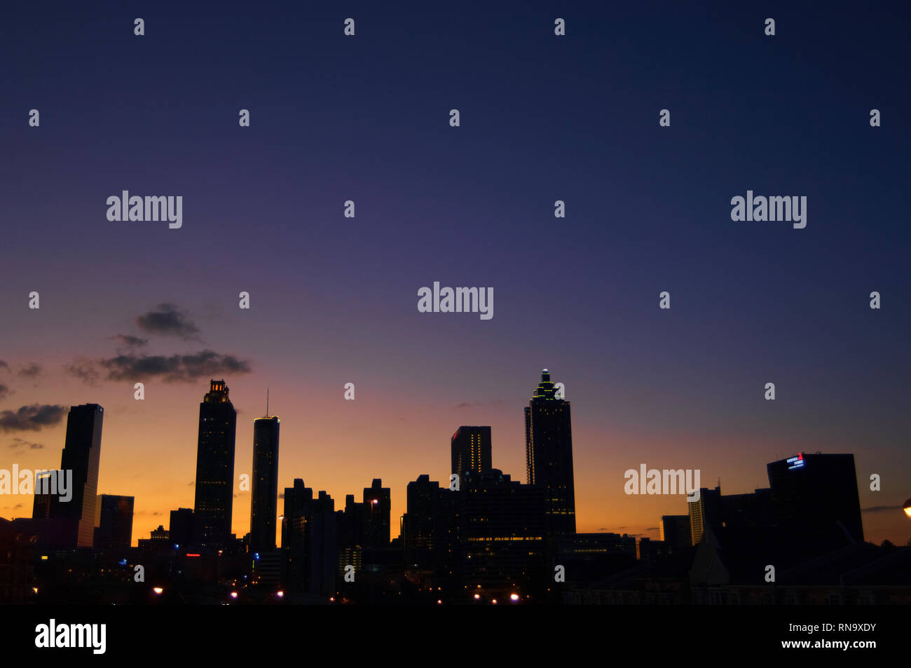 A dramatic sunset over several modern high-rise buildings in Atlanta ...