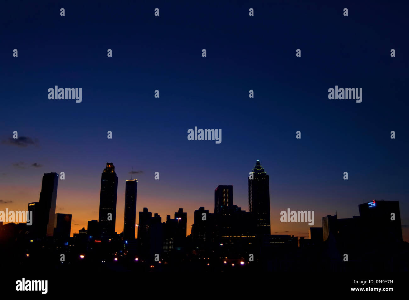A dramatic sunset over several modern high-rise buildings in Atlanta ...