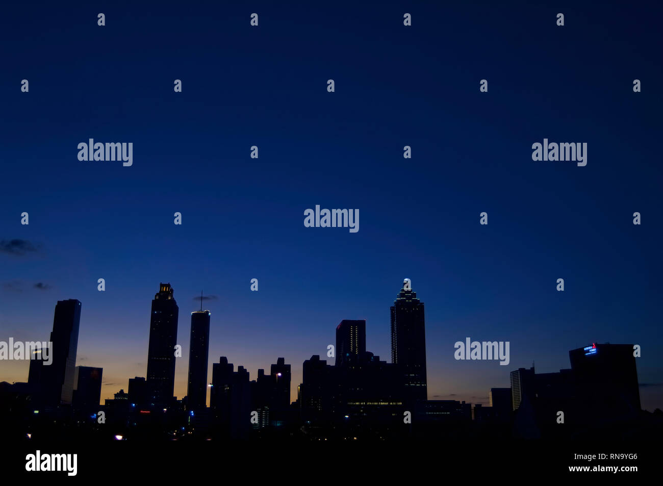 A dramatic sunset over several modern high-rise buildings in Atlanta ...