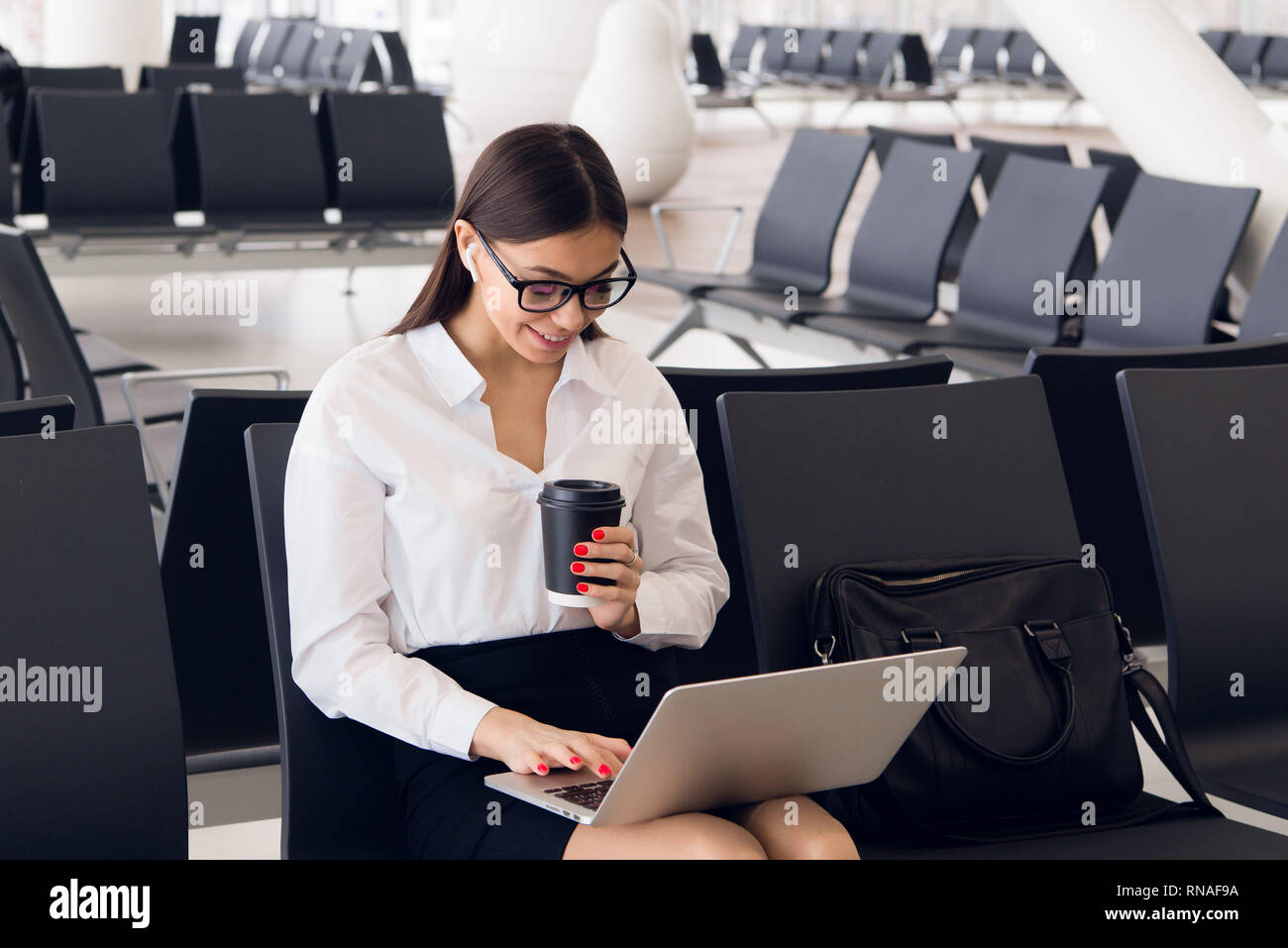 Female executive with suitcase in work related business trip waiting ...