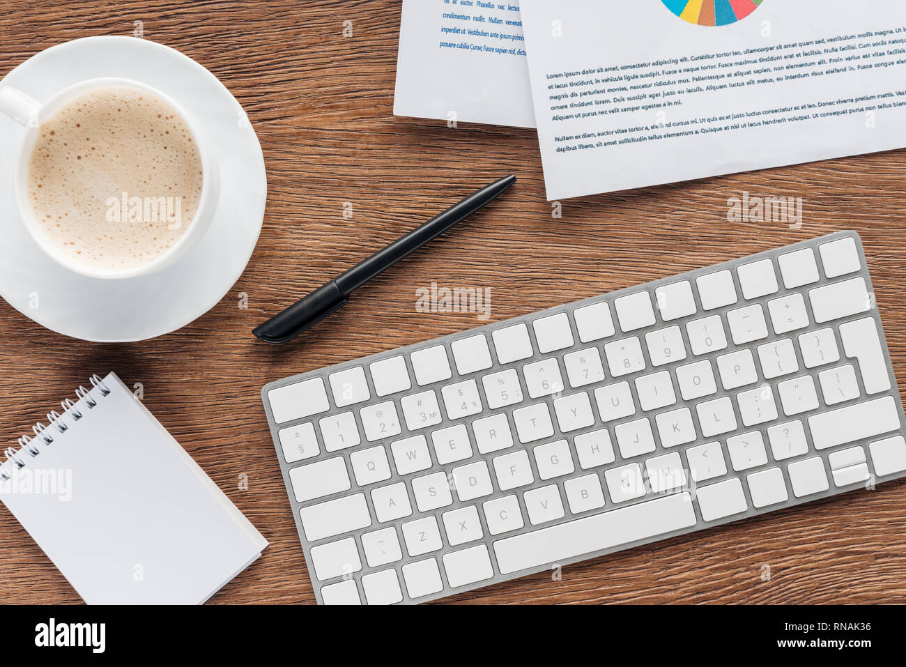 Top view of coffee cup, keyboard and documents Stock Photo - Alamy