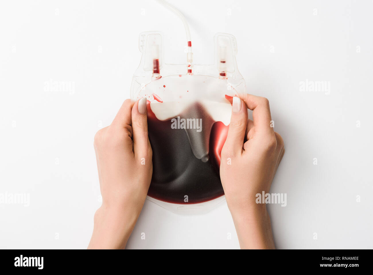 Partial view of woman holding drip with blood on white background ...